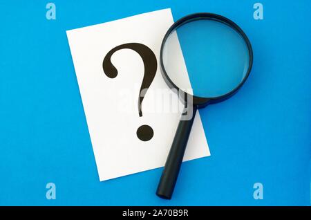 Magnifying glass and question mark icon symbol on blue background with ...
