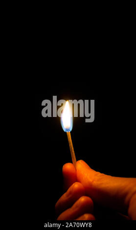 Hand holding lit match black background, studio photograph Stock Photo ...