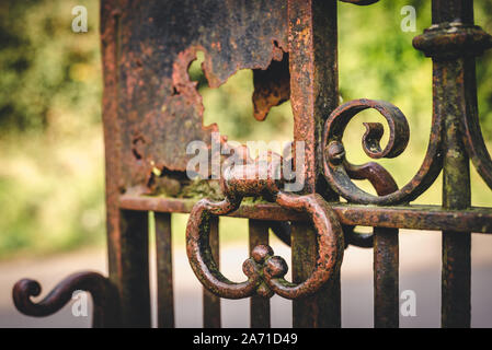 Close-up of a rusty wrought iron gate to a cemetery plot with the ...