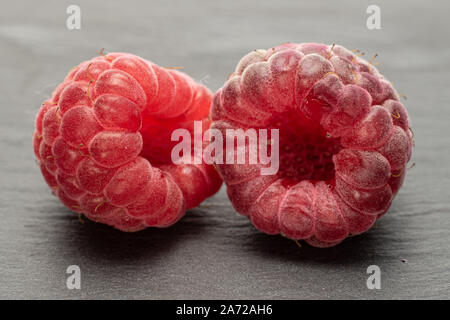 Group of two whole fresh crimson raspberry on natural wood Stock Photo ...