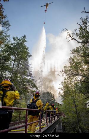 Firefighters watch water drops on the Palisades Fire in Mandeville ...