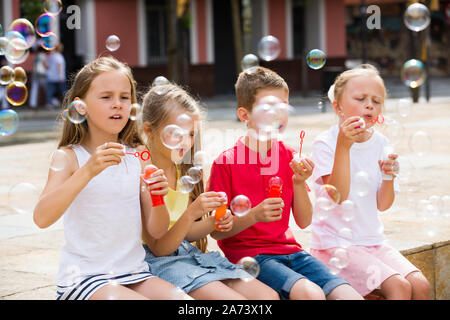 Boy blowing bubbles at yard Stock Photo - Alamy