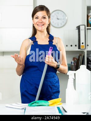 Female office cleaner is satisfied after cleaning Stock Photo - Alamy