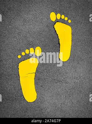 Yellow pedestrian road safety walkway sign painted a road in a car ...