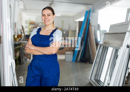 Portrait of female master who is working on her workplace in the window ...
