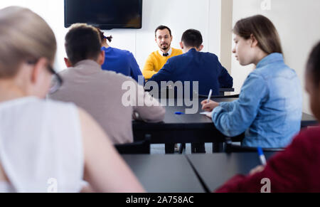 Teacher is monitoring students during exam in class Stock Photo - Alamy