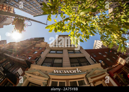 Signs announce the location of a a WeWork co-working space location in ...