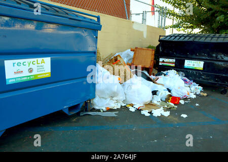 Messy trash can with trash bags and scattered garbage Stock Photo - Alamy