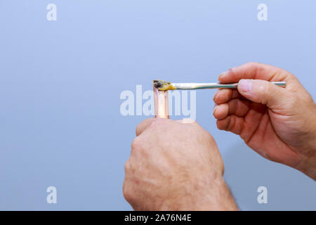 Closeup worker plumber master cleaning copper pipes with professional ...