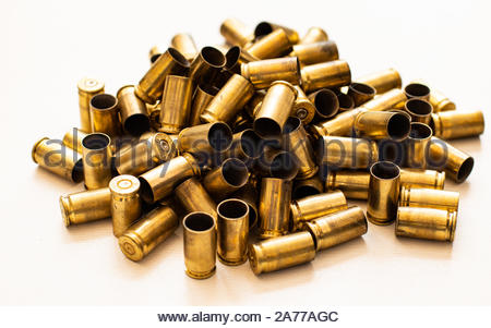 Spent shell casings pile up as a soldier fires his weapon down-range ...