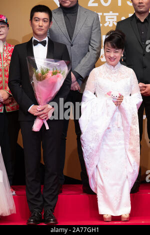 Chinese actor Du Jiang carry the Gold Crane Award while Japanese actress Kana Kurashina stand ...