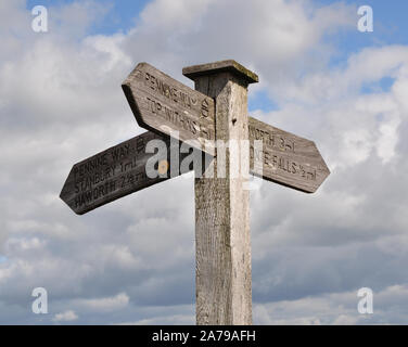 Wooden Pennine Way and Yorkshire Three Peaks signpost covered in frost ...