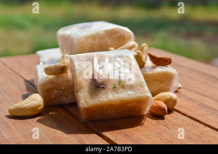 Soan Papdi is a popular Indian cube shape flakey crispy dessert. Served ...