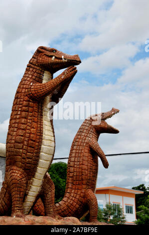 PHICHIT, THAILAND – 1 OCTOBER 2019 : Crocodile statue name Phaya Chalawan and two female ...