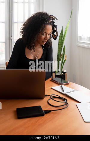 Successful business woman working in an office at a table, showing a ...