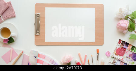 Overhead shot of pink feminine designer workspace with laptop computer ...