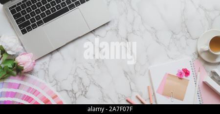 Overhead shot of pink feminine designer workspace with laptop computer ...