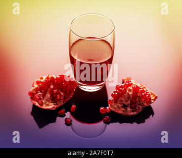 pomegranate juice in a glass and pomegranate with reflection Stock ...