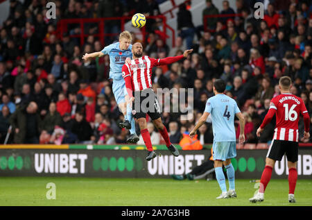 Sheffield United's Ben Mee (left) and Derby County's Ben Brereton Diaz ...