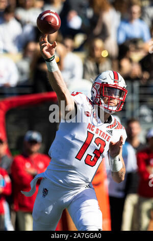 North Carolina State's Devin Leary (13) avoids a sack against ...