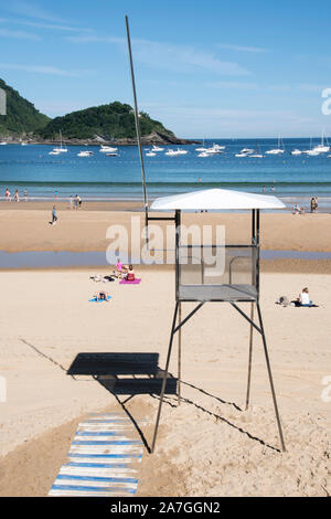 La Concha beach with boats and people Stock Photo - Alamy