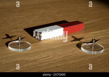 needles and magnet on a white background Stock Photo - Alamy