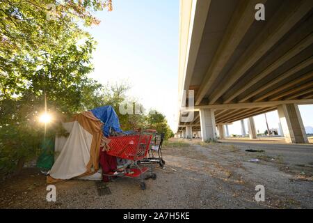Homeless people living in an encampment below a bridge over the Stock ...