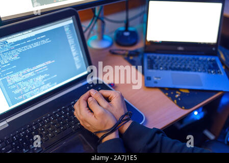 Hacker hands tied with wires, crime lifestyle Stock Photo - Alamy