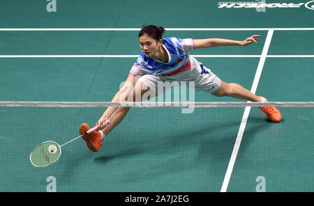 Han Yue of China returns a shot to Sayaka Takahashi of Japan during the ...