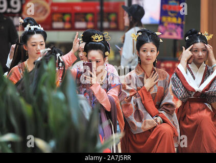 Beauties dressing in ancient Chinese clothes prepare to demonstrate and ...