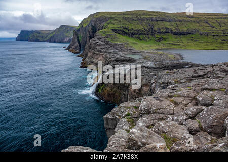 Bosdalafossur waterfall on Vagar island coastline in sunset, Faroe ...