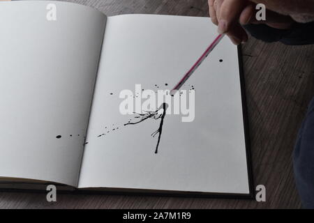 Ink being blown by straw on paper, series of pics in a sequence Stock ...