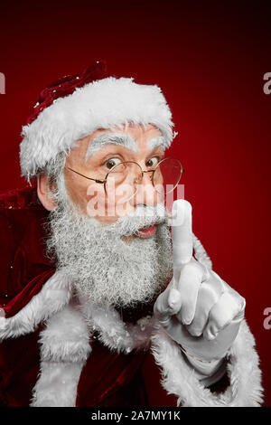 Santa Claus shushing Stock Photo - Alamy