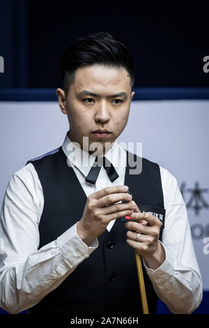 Xiao Guodong of China chalks his cue as he considers a shot to Graeme ...