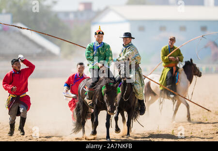 Chinese equestrians take part in a horse training contest in Huhhot ...