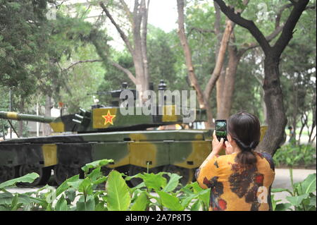 Citizens pose to photo with warcraft, tank, machine gun and other army ...