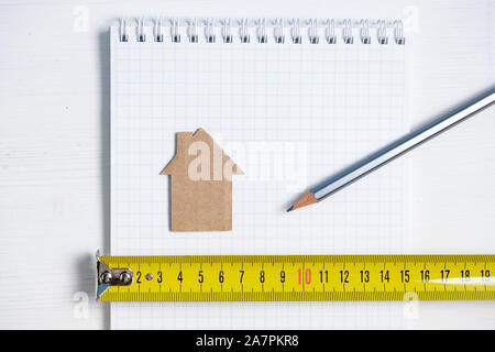 Cardboard cutout house, roulette, pencil, calculator, wrench and blank ...