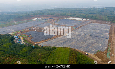 Chinese workers sort out and bury kitchen waste at the Jiangcungou ...
