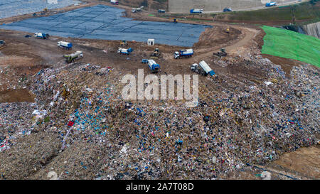 Chinese workers sort out and bury kitchen waste at the Jiangcungou ...