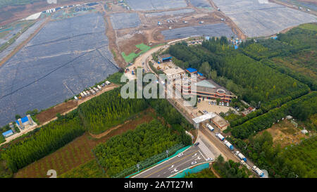 Chinese workers sort out and bury kitchen waste at the Jiangcungou ...