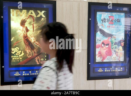 A Chinese filmgoer views a poster of Chinese animated film "Ne Zha" at ...