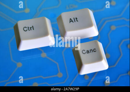 Keyboard keys form the word CTRL ALT CANC on black electric circuit in ...
