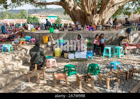 Ethiopian traditional Coffee ceremony women in traditional dress preparing bunna coffee in Addis ...
