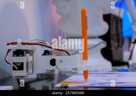 Robotic arm with pen drawing portrait Stock Photo - Alamy