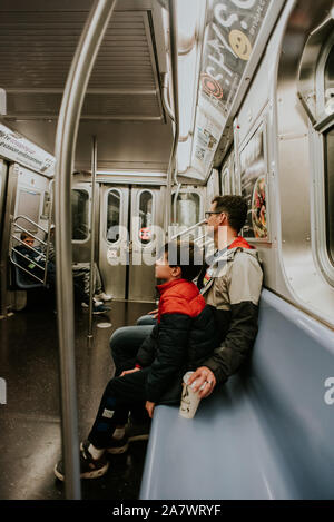 Caucasian man riding subway train Stock Photo - Alamy