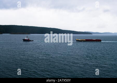 Tug boat towing a log barge in the Swanson Channel Stock Photo - Alamy