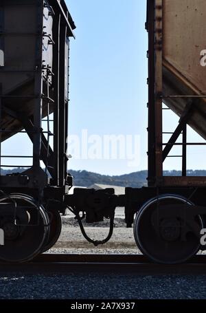 Coupling between two railway cars on tracks Stock Photo - Alamy