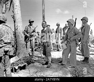 World War II Photo - wounded Japanese prisoner with group of marine ...