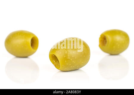 Group of three whole pitted green olive two in focus isolated on white ...