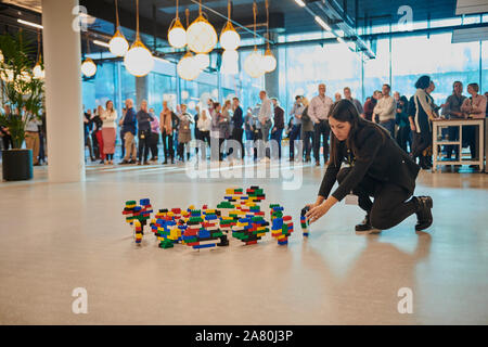 Lego Employee building Lego Challenge Stock Photo - Alamy